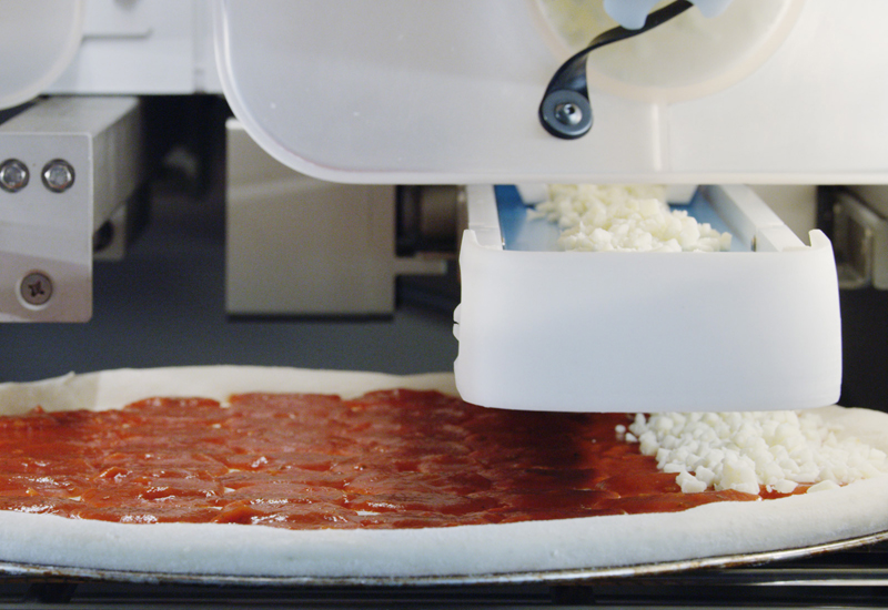 Automated pizza assembly station lands first university contract